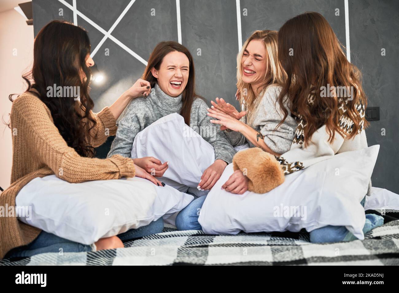 Young women enjoying winter weekends inside contemporary barn house ...