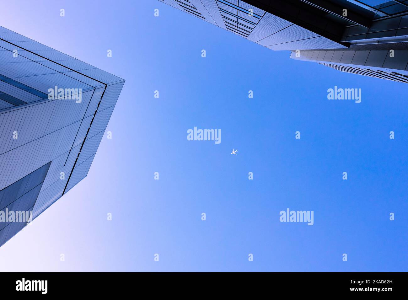 A low angle shot of two skyscrapers on a blue sky background Stock ...