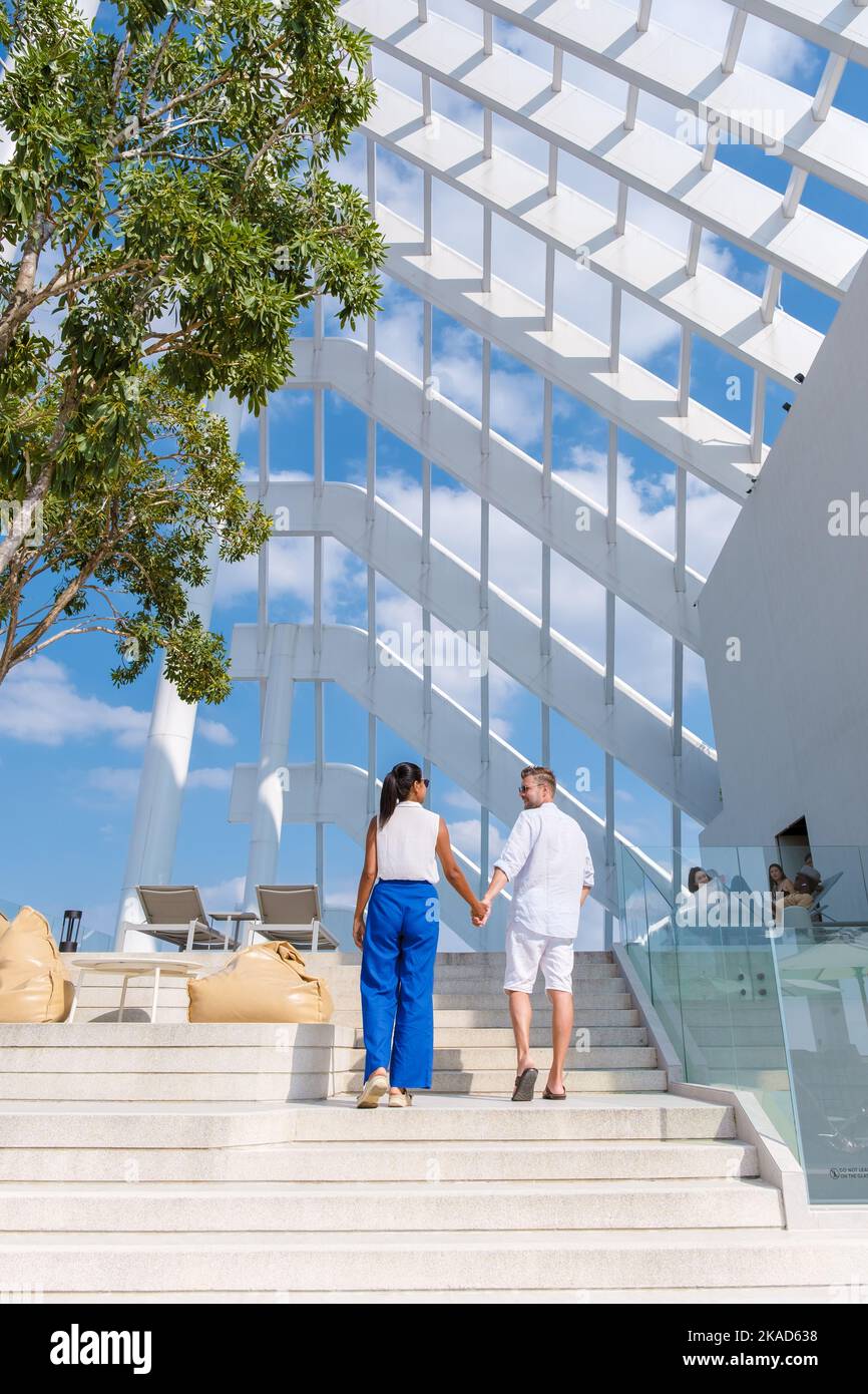 couple men and women relaxing at a rooftop pool of a luxury hotel Stock ...