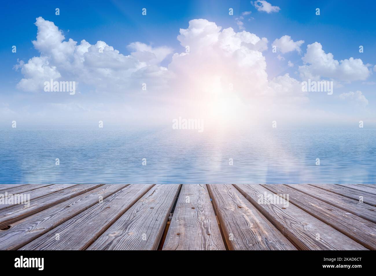 A beautiful shot of the sun hiding behind the clouds over a seascape ...