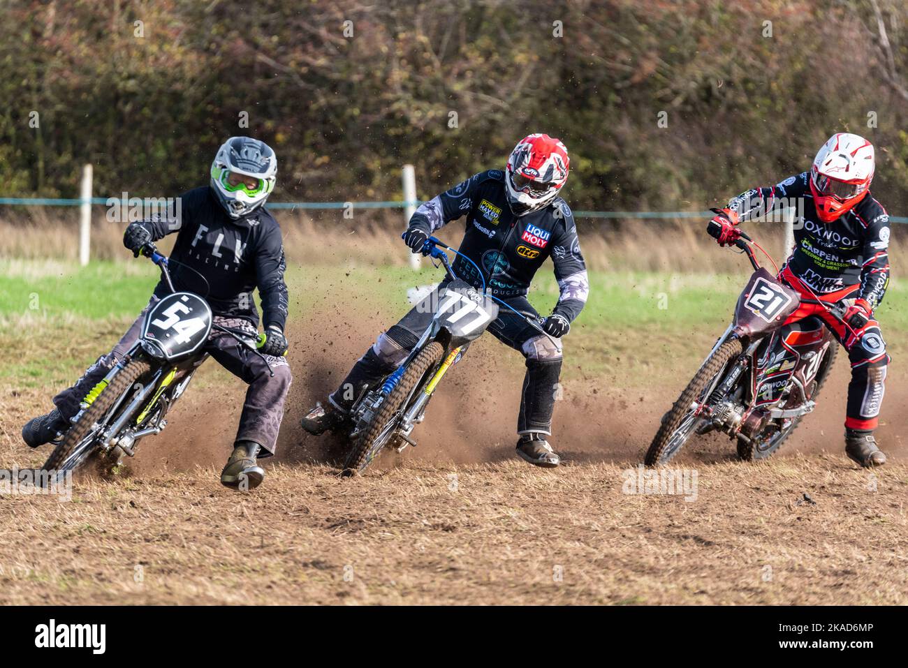 GT140 solo class riders racing in grasstrack motorcycle race. Donut ...