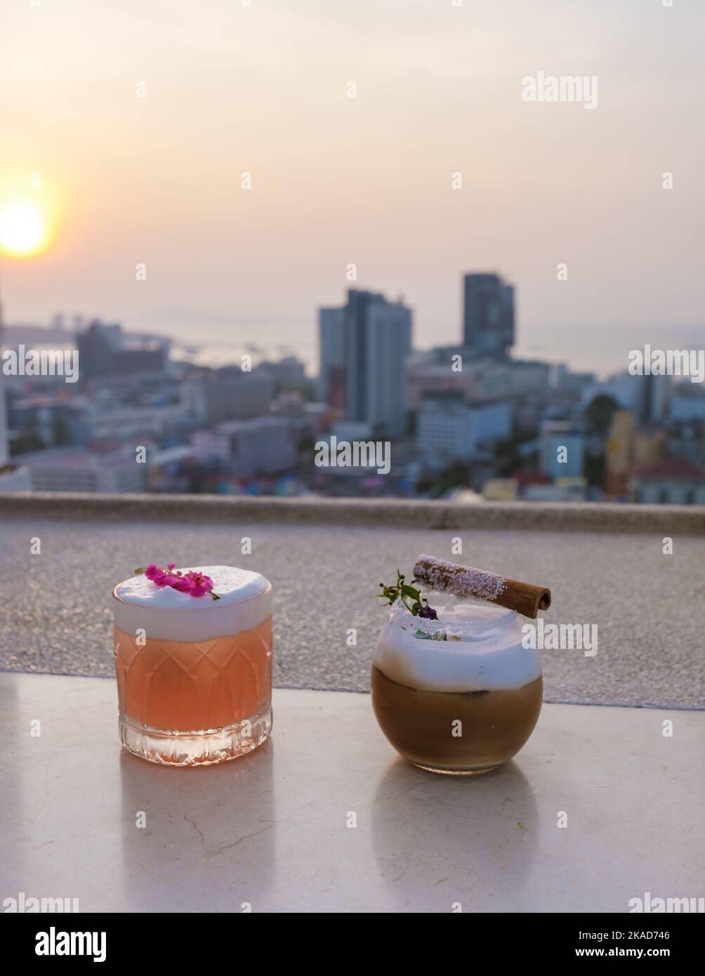 cocktail drinks on a rooftop bar in Pattaya Thailand during sunset ...