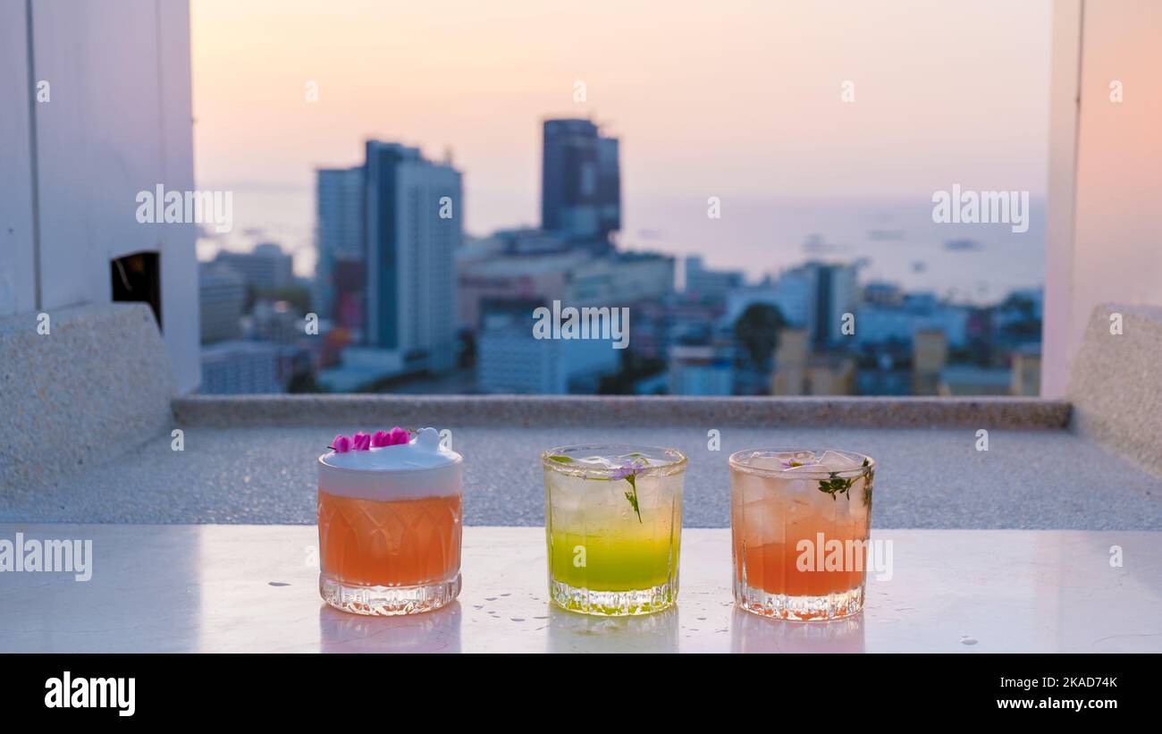 cocktail drinks on a rooftop bar in Pattaya Thailand during sunset ...