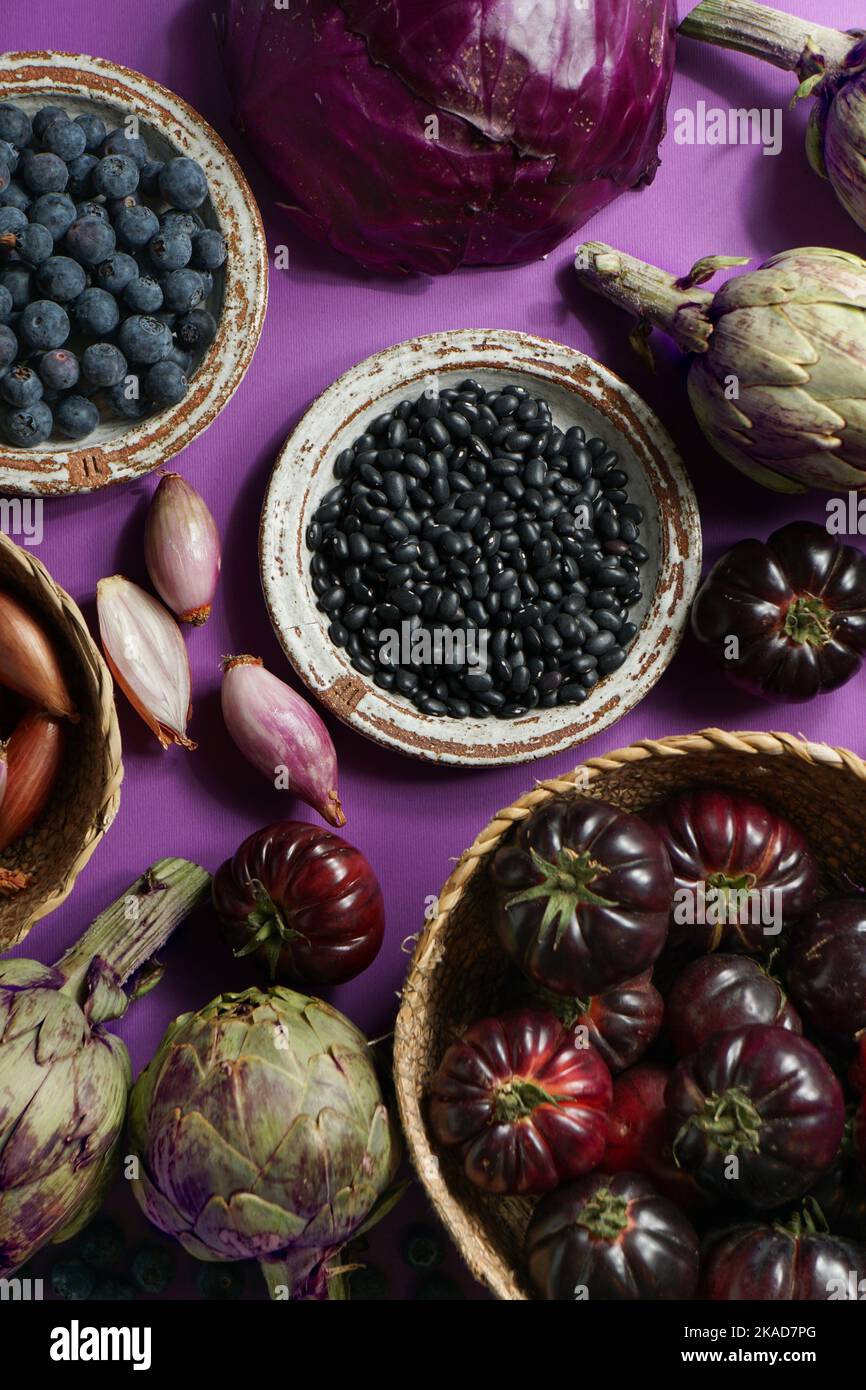 purple and red, violet vegetables on the purple background, top view ...