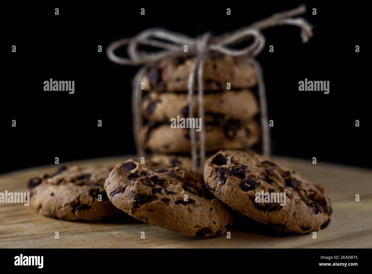 A closeup shot of the stack of tasty chocolate cookies on the wooden ...