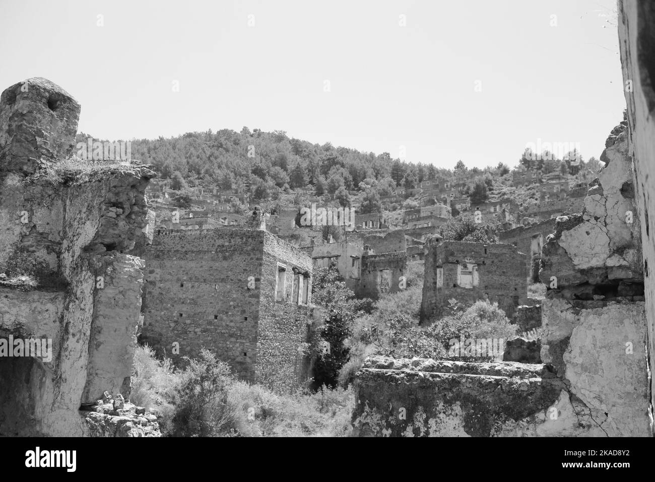 A grayscale shot of Kayakoy, an abandoned village in southwest Turkey ...