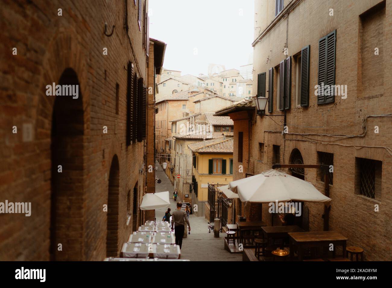 A beautiful view of a narrow alley with restaurants and cafes between ...