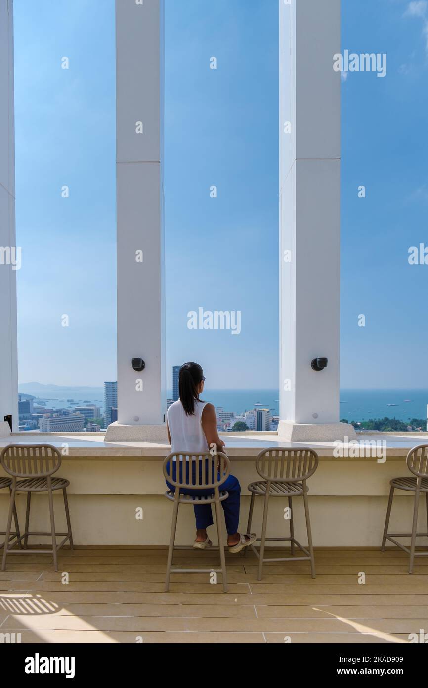 young Thai women visiting a rooftop bar looking out over the city Stock ...