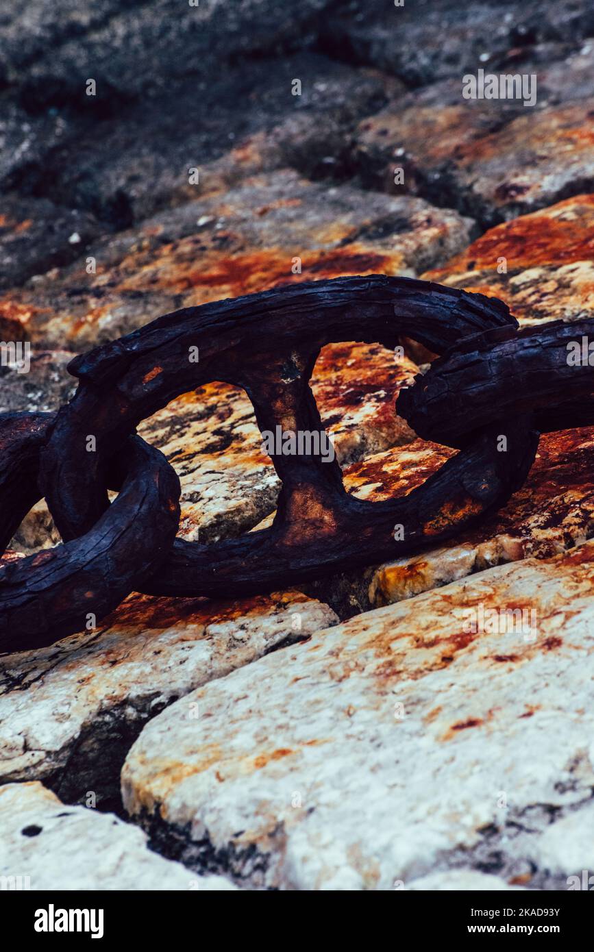 The Rusted heavy duty tense chain on the rock Stock Photo - Alamy