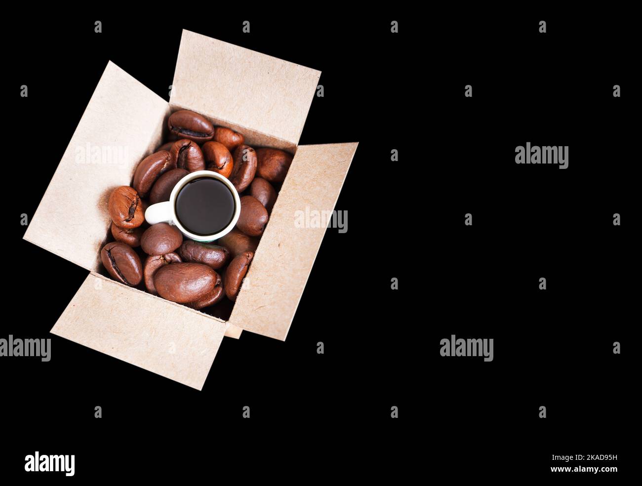 Roasted coffee beans and a tiny espresso cup in a miniature shipping ...