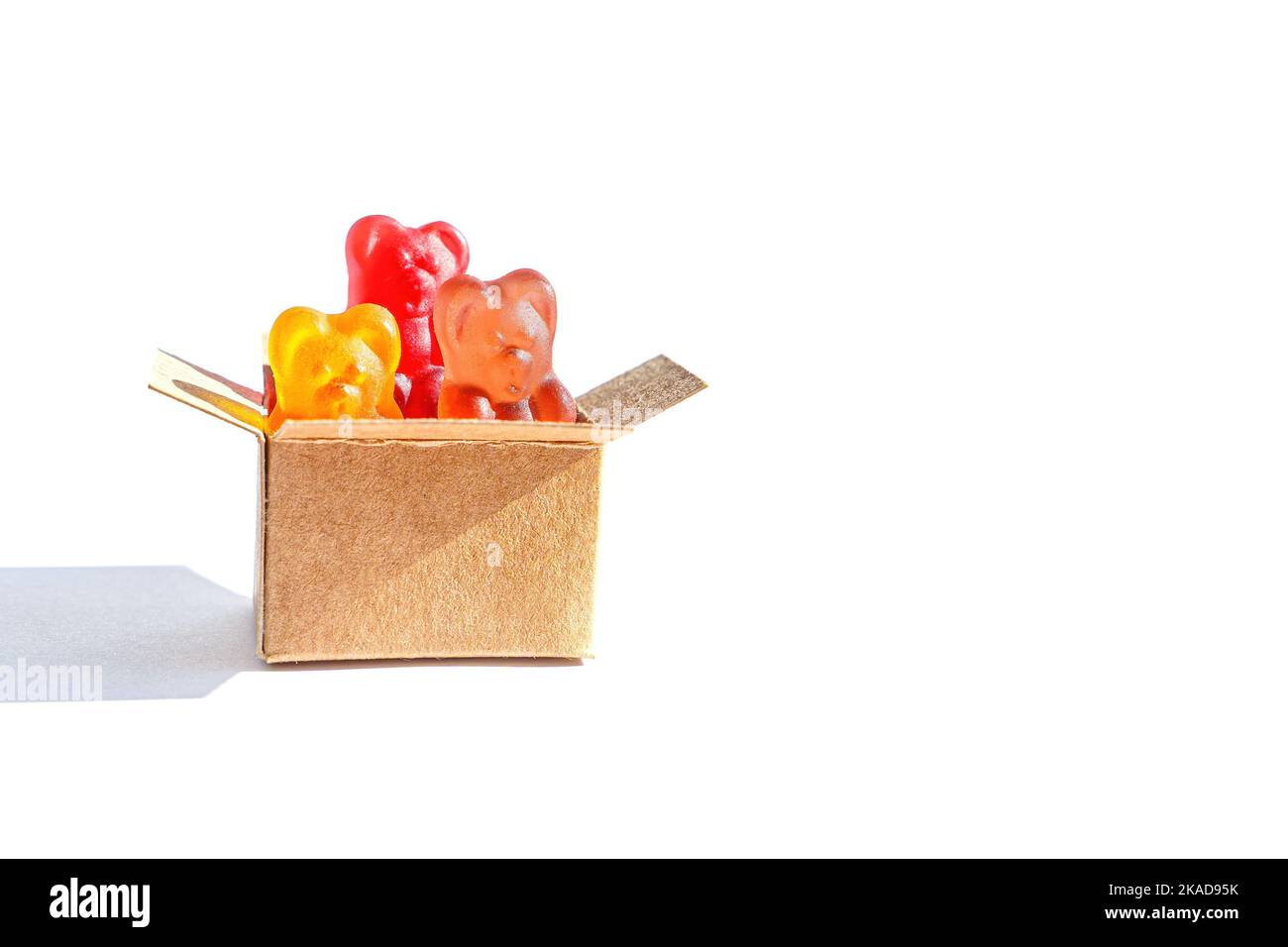 Cardboard box with gummy bears isolated on white background with copy ...