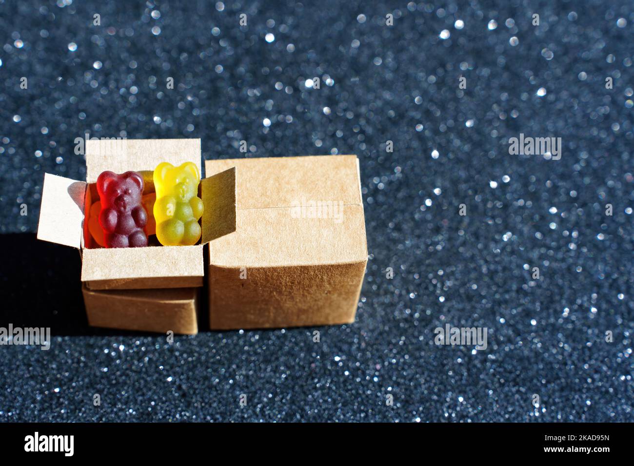 Open miniature shipping box with colorful bear shaped gummy candies ...