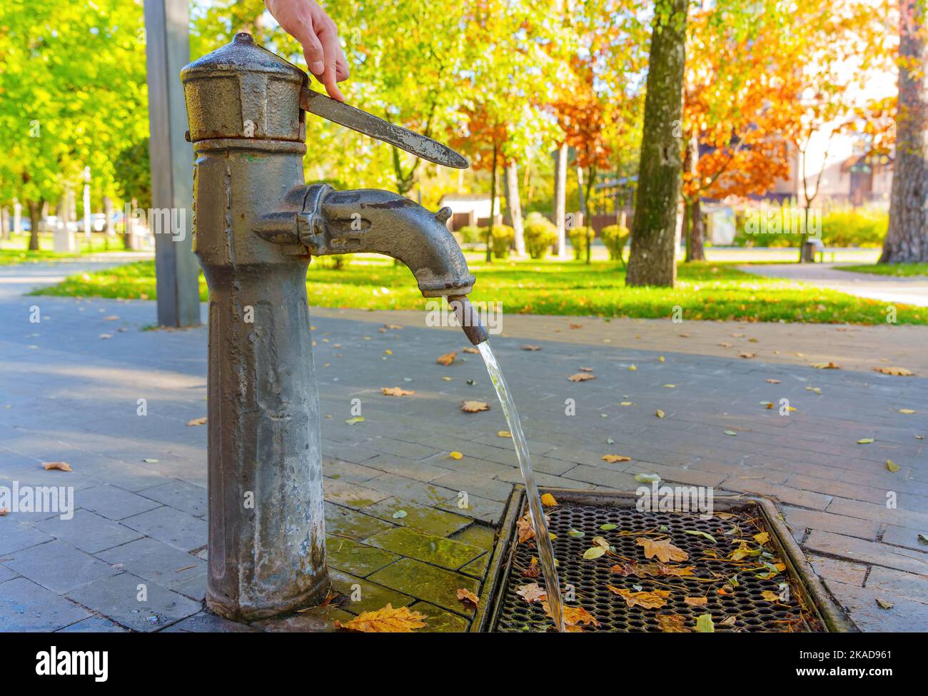 Finger pressing the lever of the drinking well water pump Stock Photo ...