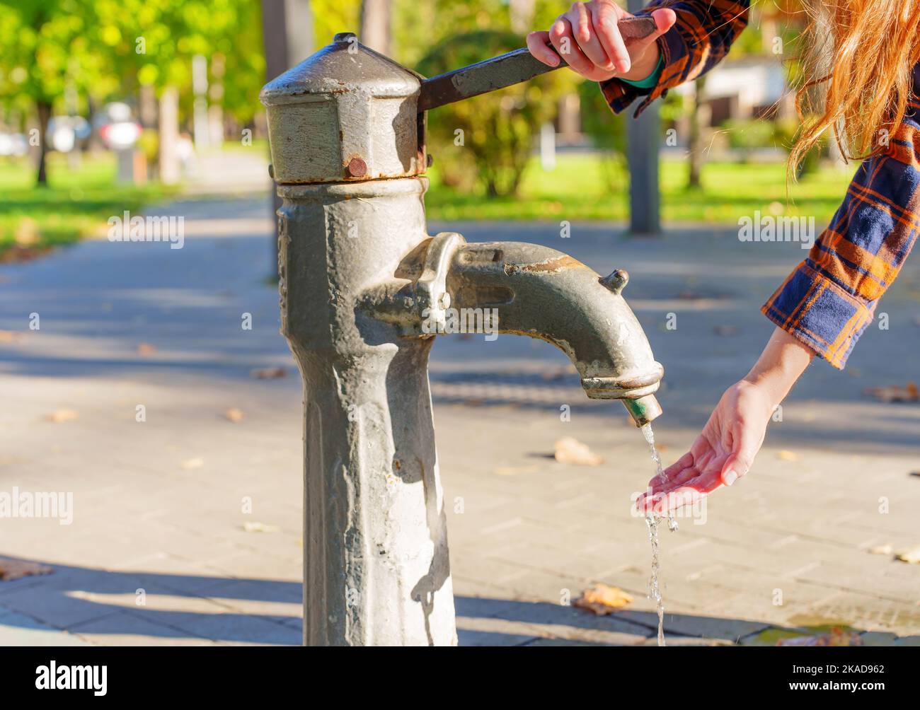 Female testing the public well water supply system outdoors. Drinking ... Female testing the public well water supply system outdoors. Drinking ...