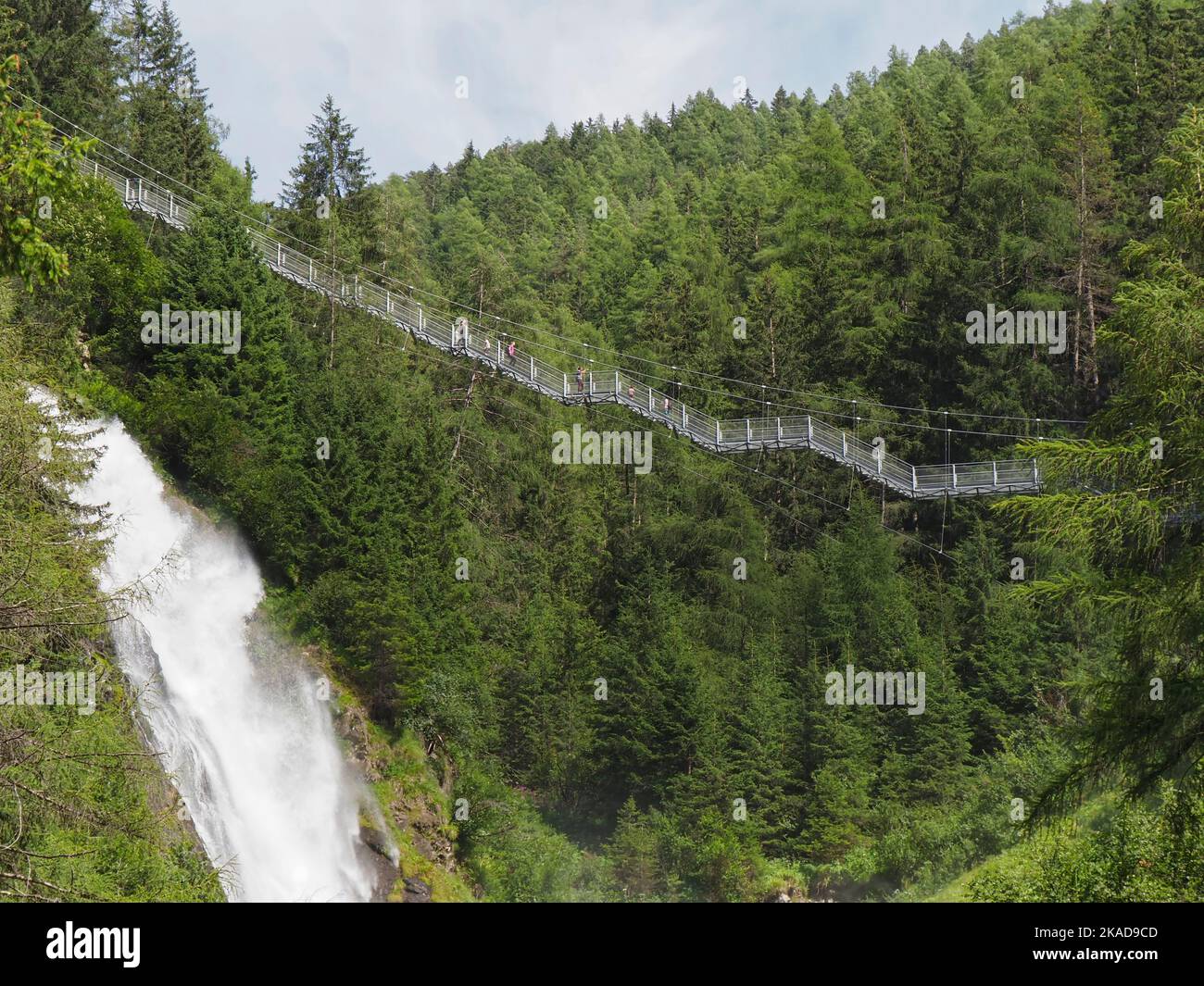 people cross the stepped suspension bridge to get to the top of ...