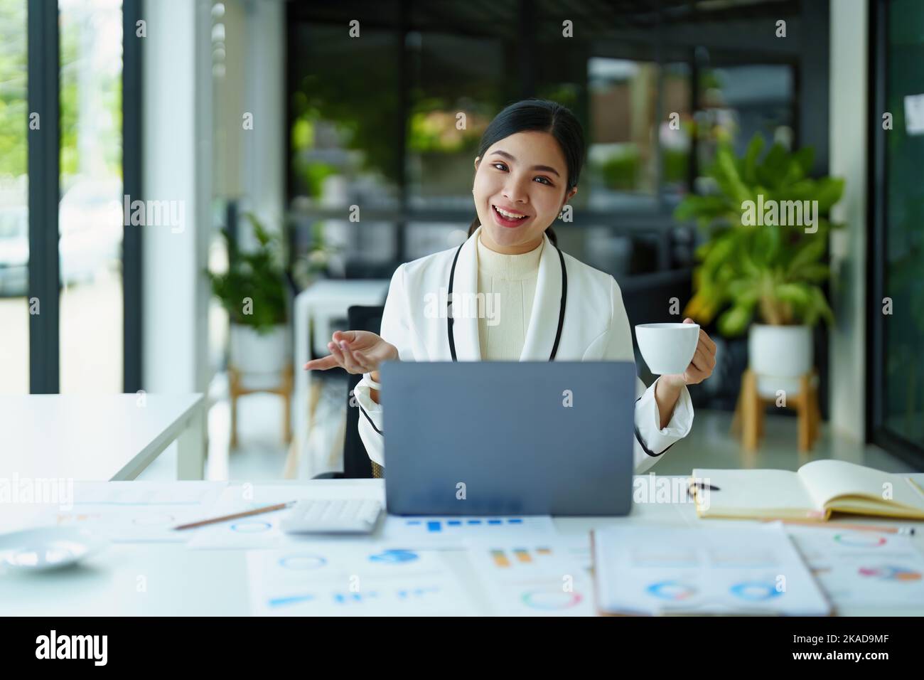 Portrait of a female employee using a computer for video conferencing ...