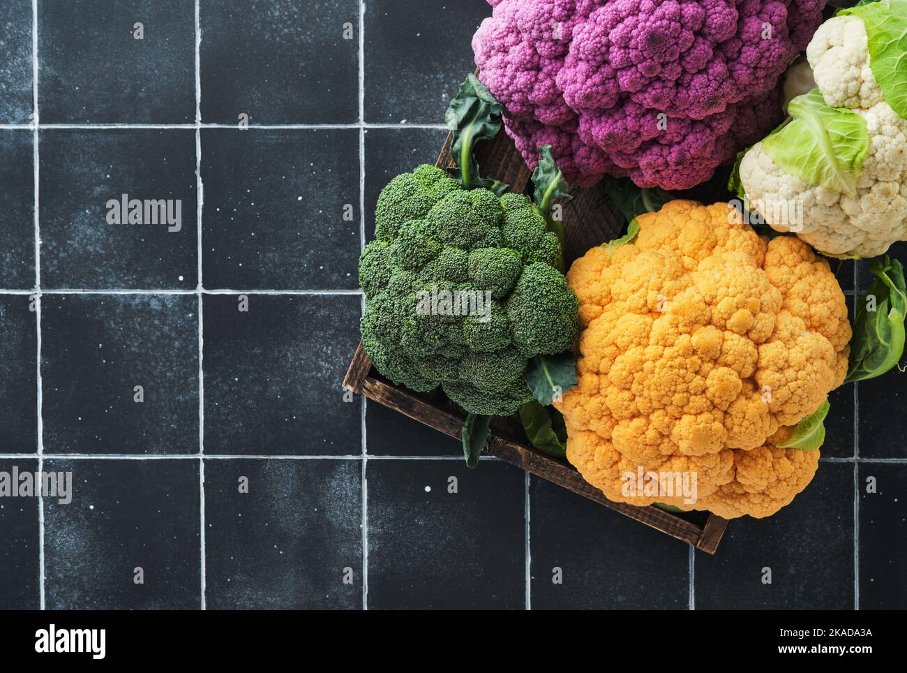 Colorfu cauliflower. Various sort of cauliflower on old stone tiles ...