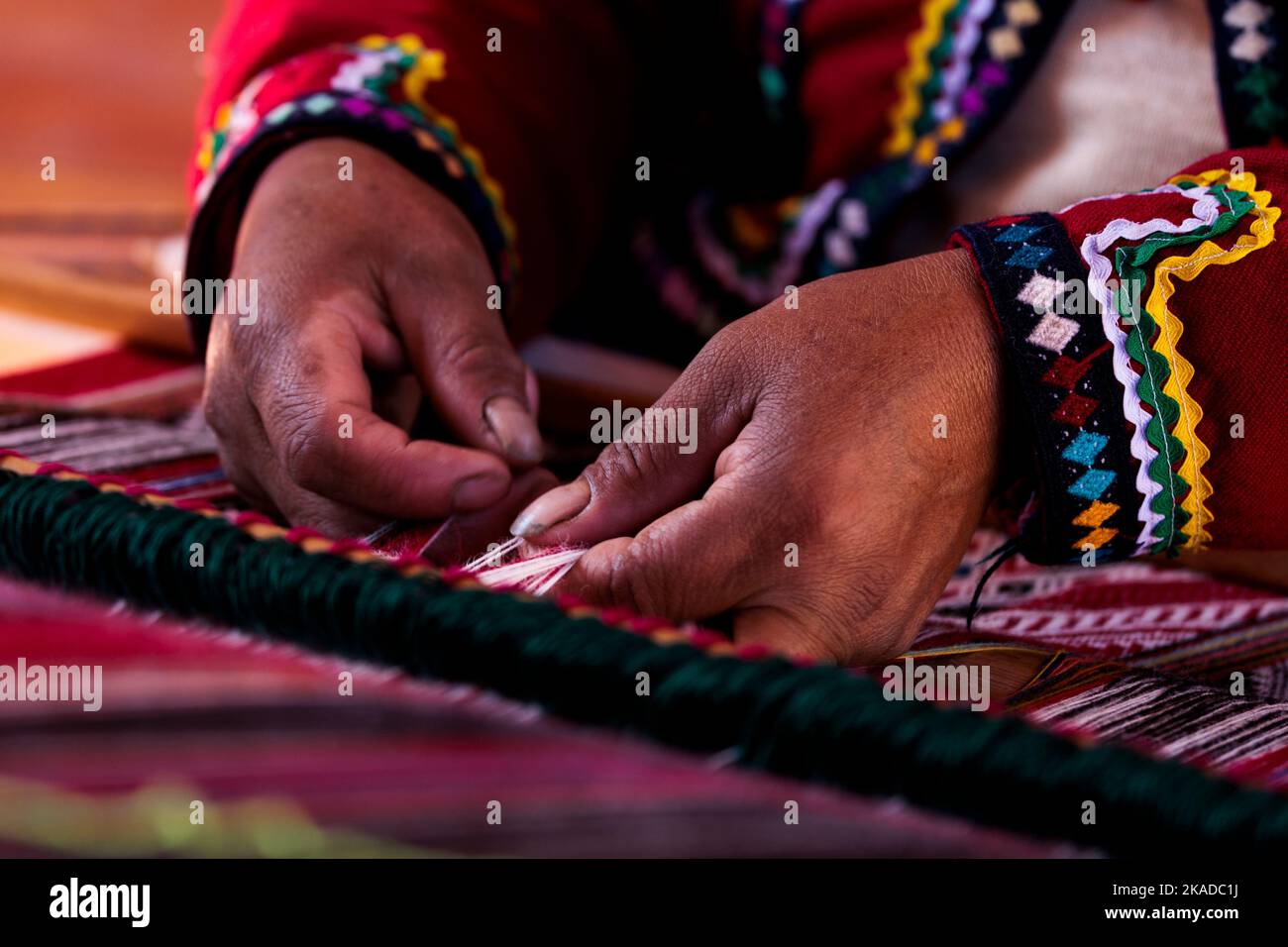 A close up of hands doing traditional Peruvian weaving Stock Photo - Alamy