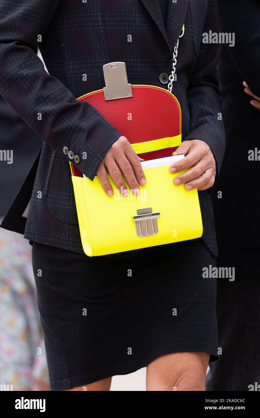 Milan, Italy - September, 21, 2022: woman wears yellow iconic clic ...