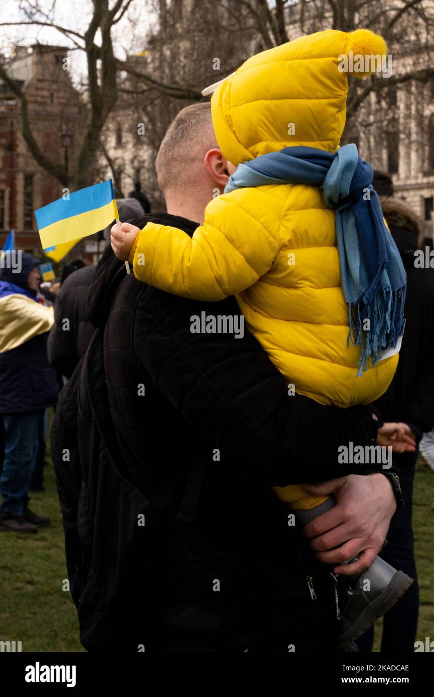 A vertical shot of a father with a child during a protest for ending ...