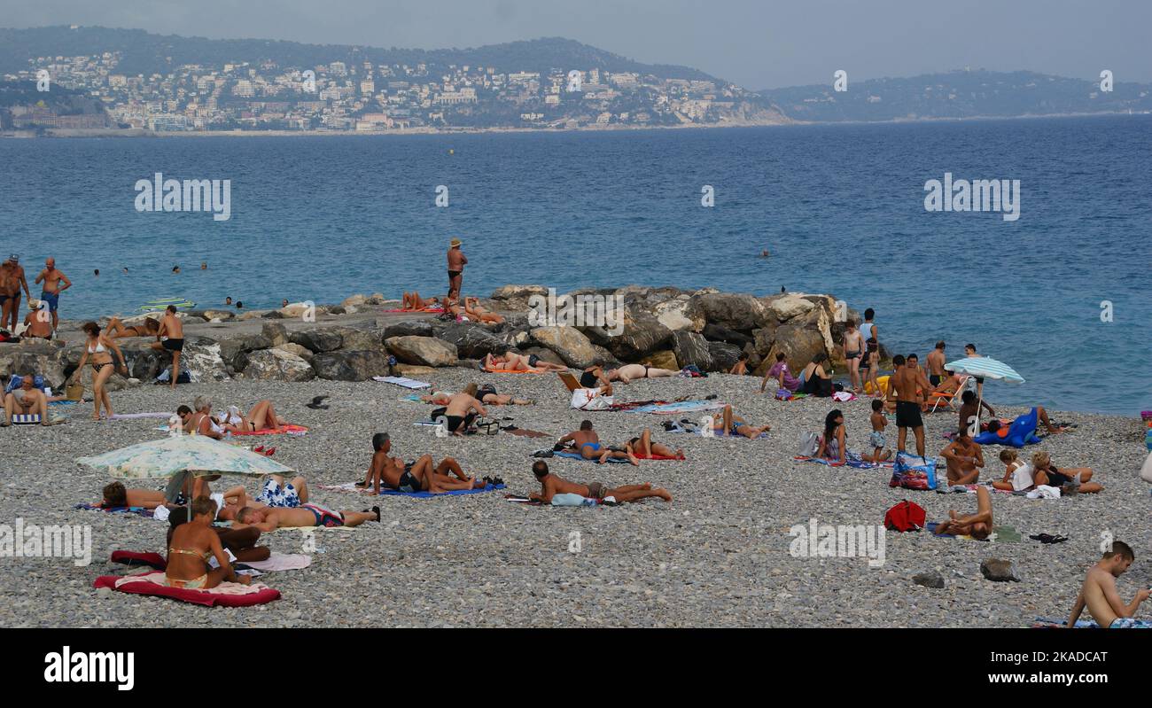A group of people at the Cote d'Azur beach in Nice, France during ...