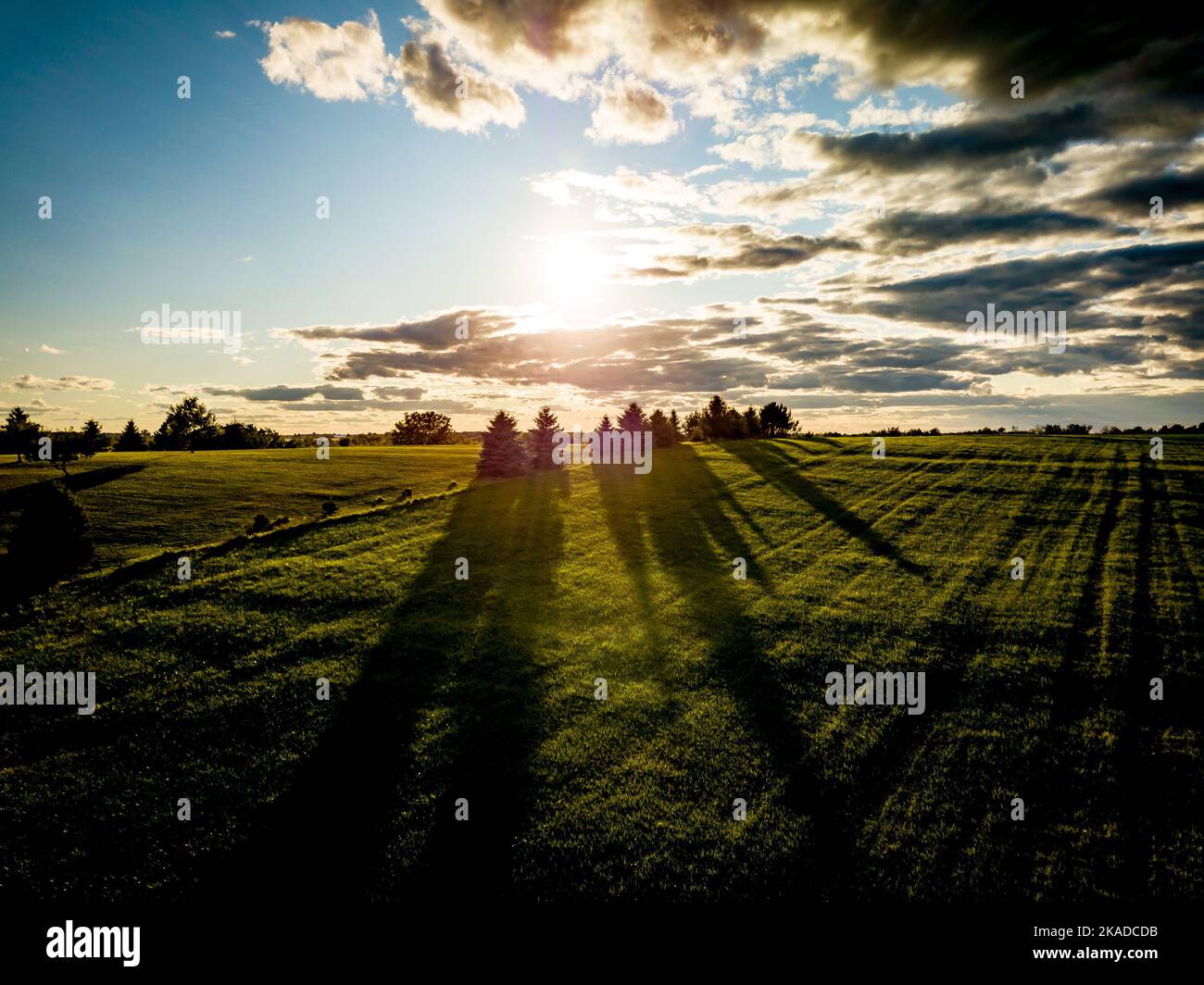 A bird's eye view of green fields at sunset near Owasco Lake in Auburn ...