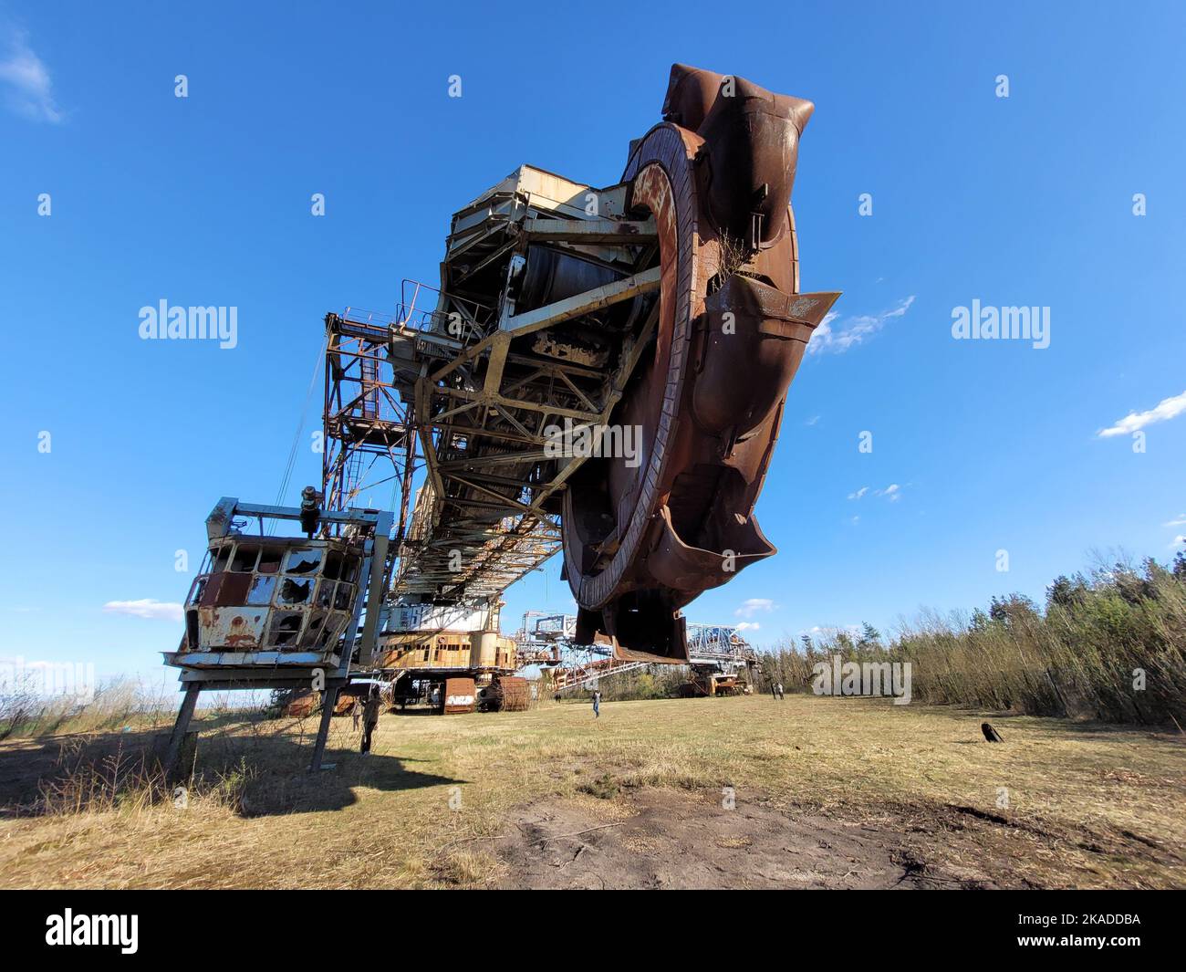 A bucket-wheel excavator Bagger in a reen field under the clear sky ...