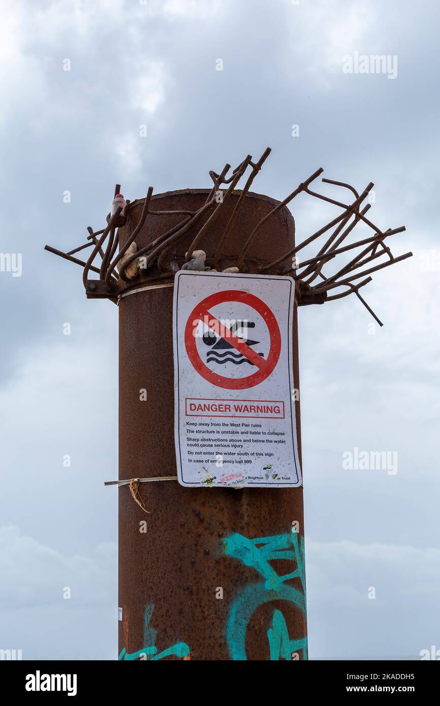 Warning sign, Ruins of West Pier, destroyed by fire in 2003, Brigthon ...