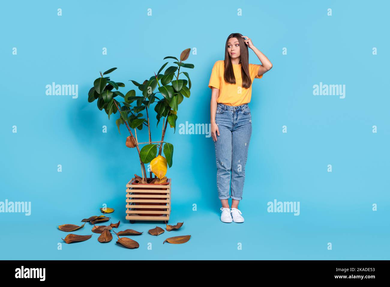 Photo of doubtful funny young lady wear yellow t-shirt looking dried ...