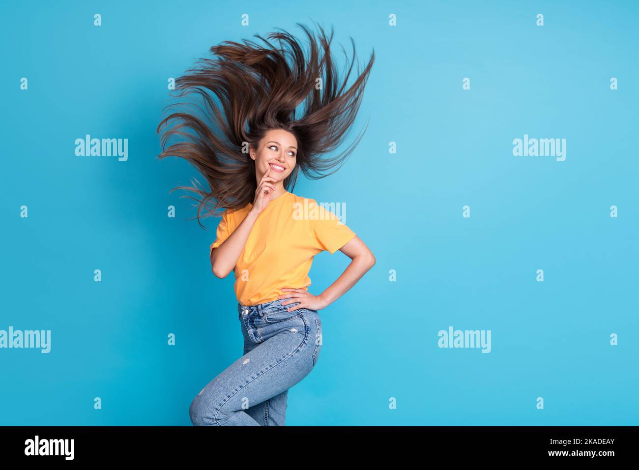 Photo of adorable dreamy lady wear yellow t-shirt hair fluttering air blowing finger chin ...