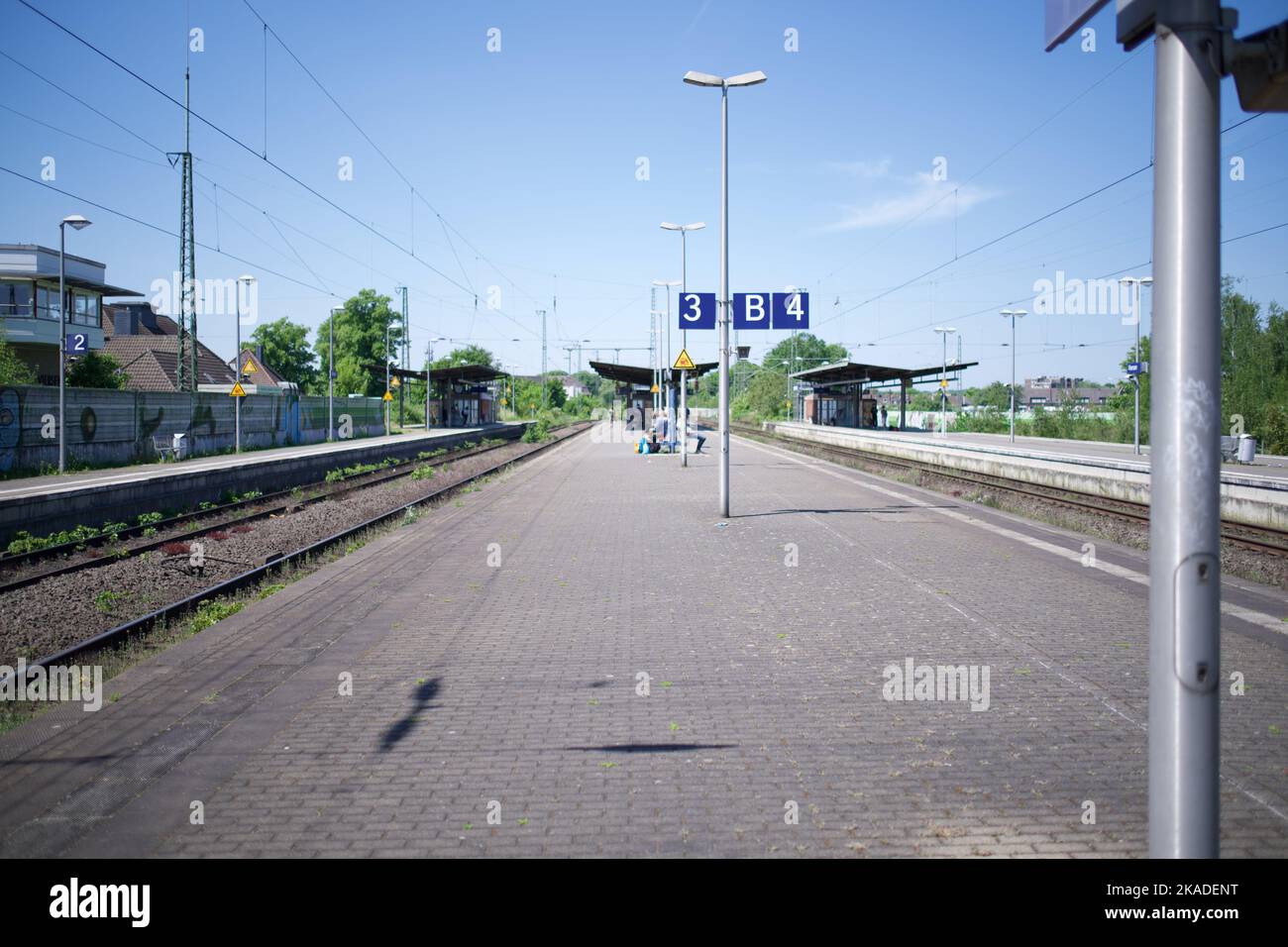 The outdoor train station platform with metal poles against the blue ...