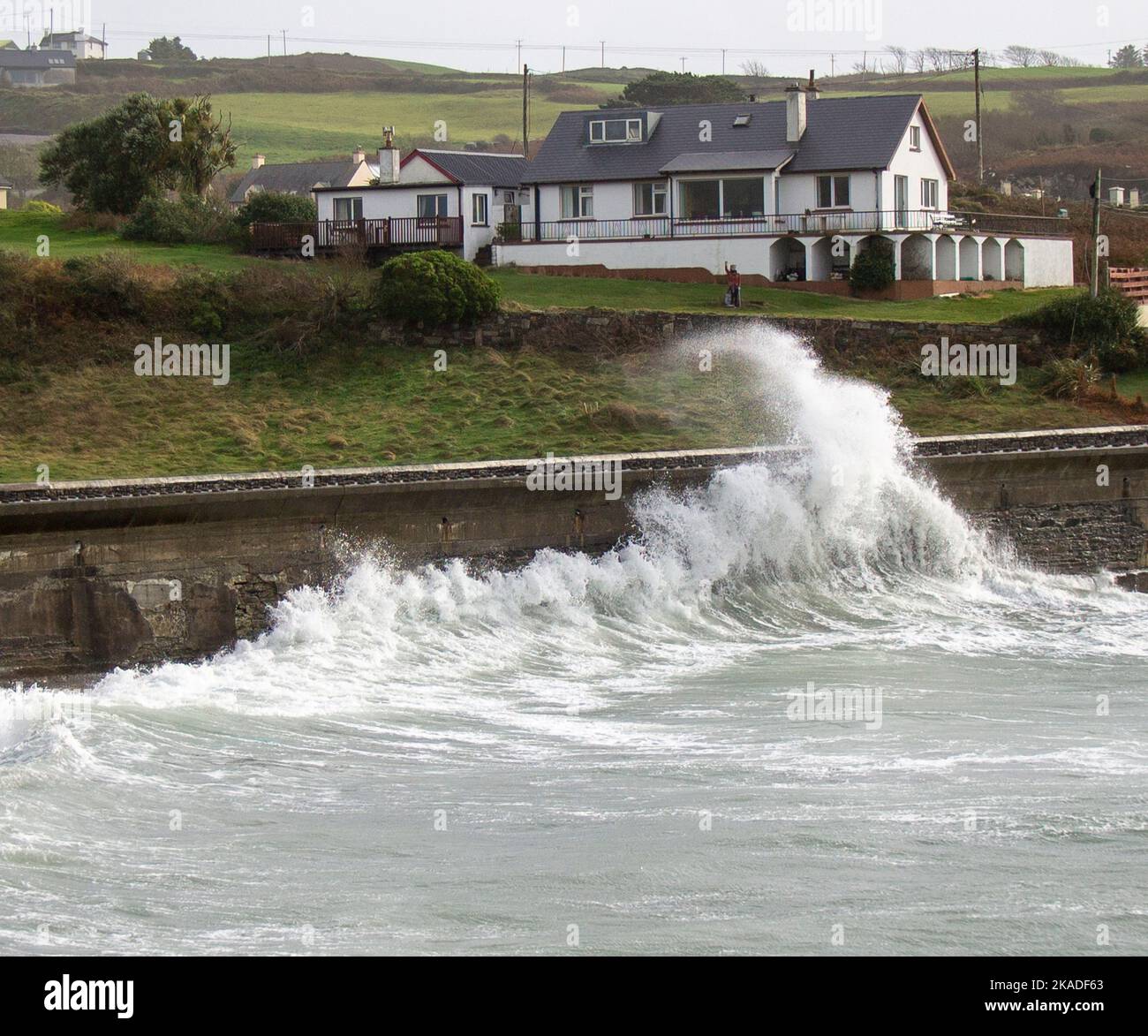 Storm surge waves breaking over the sea defences. Tragumna, West Cork ...