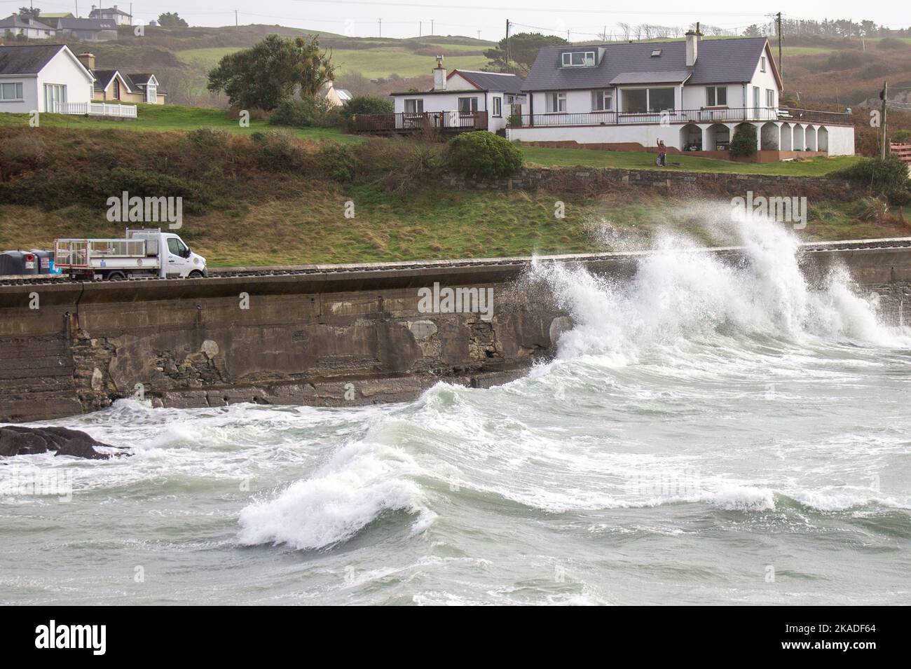 Storm surge waves breaking over the sea defences. Tragumna, West Cork ...