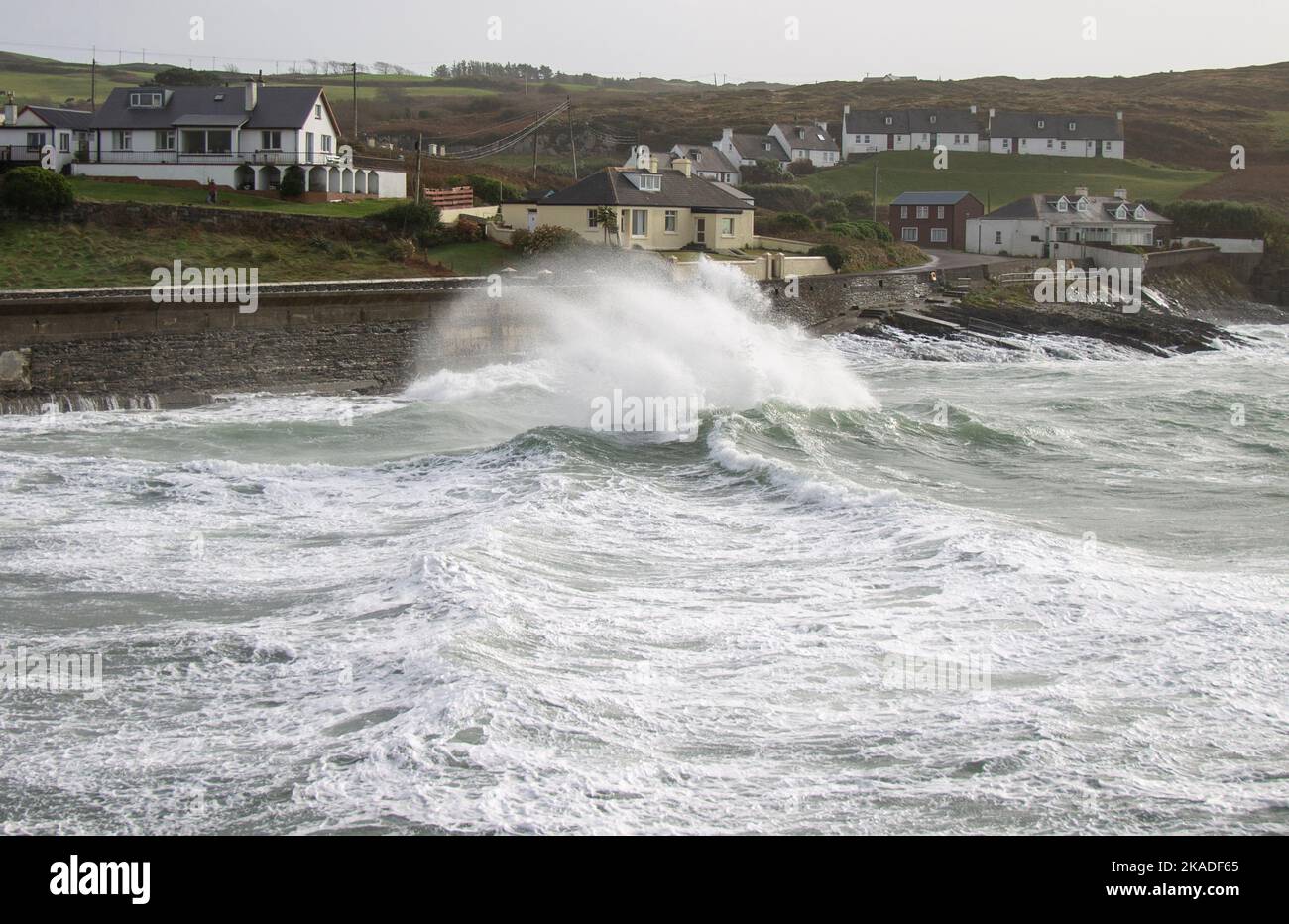 Storm surge waves breaking over the sea defences. Tragumna, West Cork ...