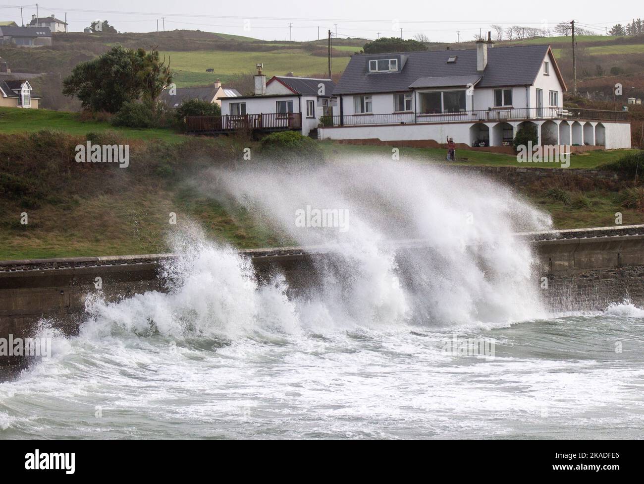 Storm surge waves breaking over the sea defences. Tragumna, West Cork ...