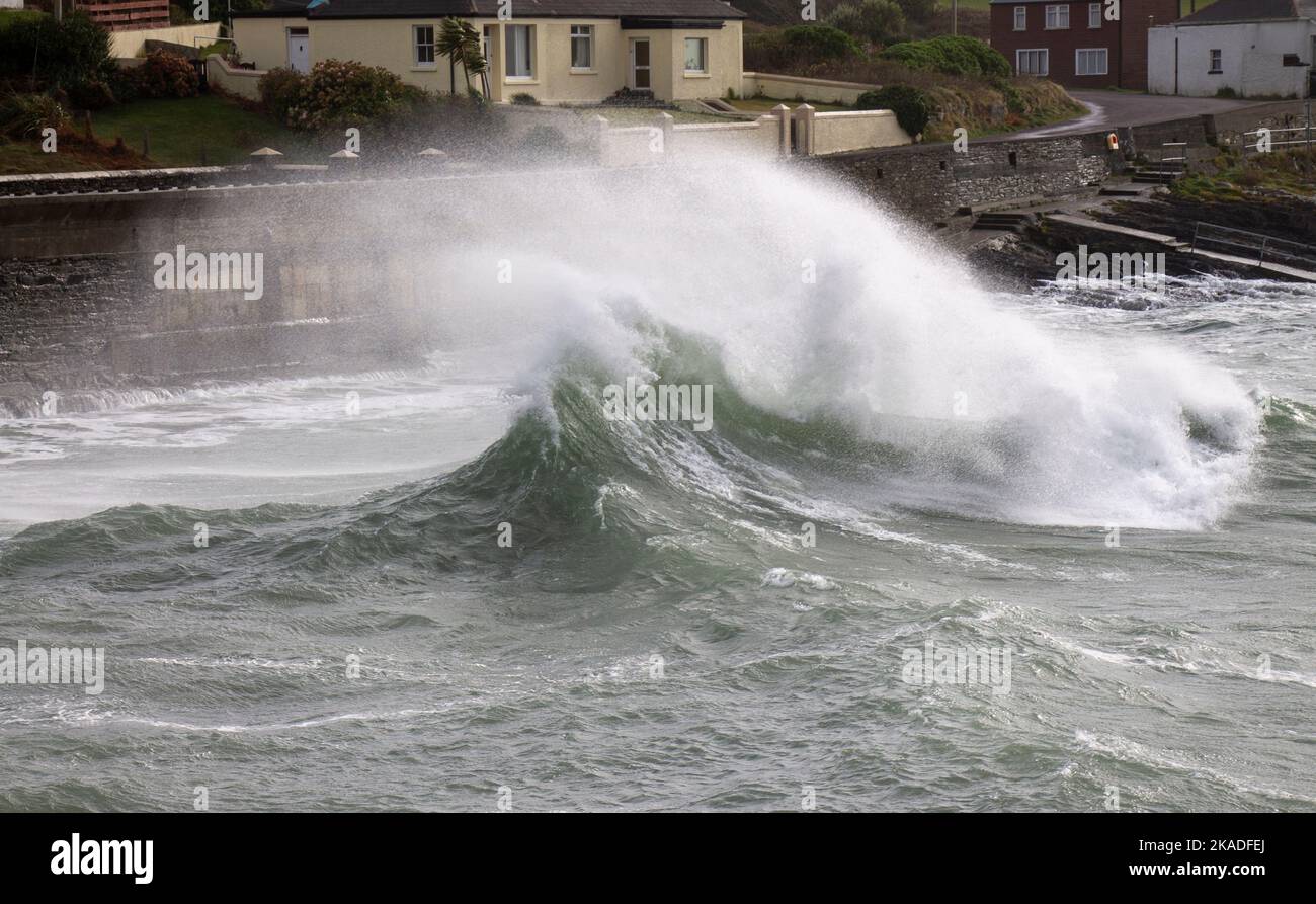 Storm surge waves breaking over the sea defences. Tragumna, West Cork ...