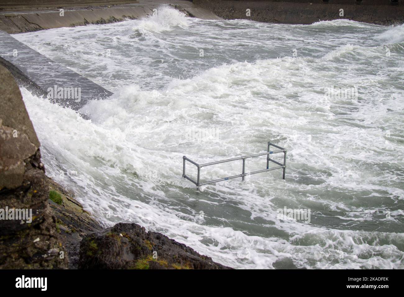 Storm surge waves breaking over the sea defences. Tragumna, West Cork ...