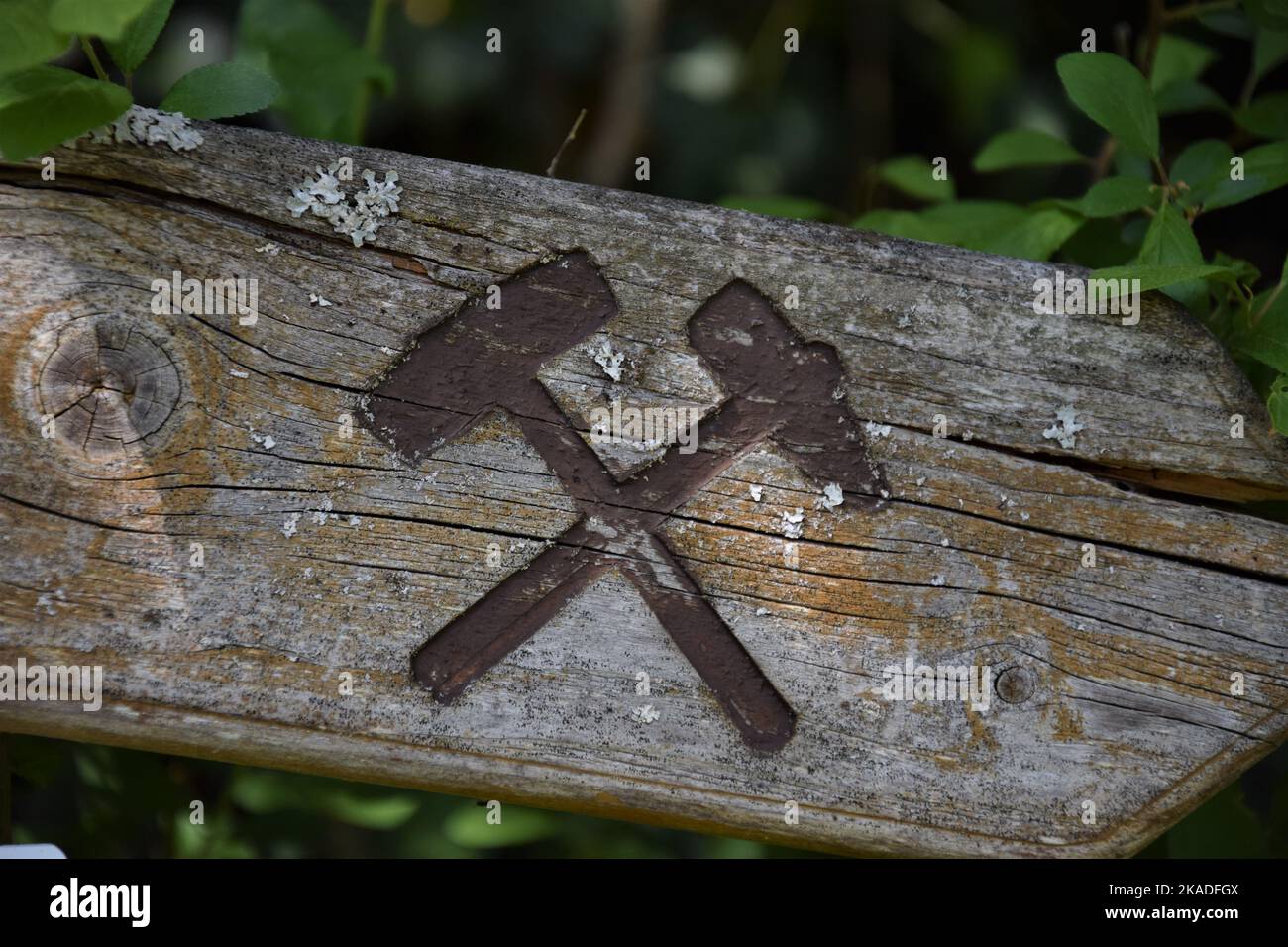 old sign with a mine symbol made from wood Stock Photo - Alamy