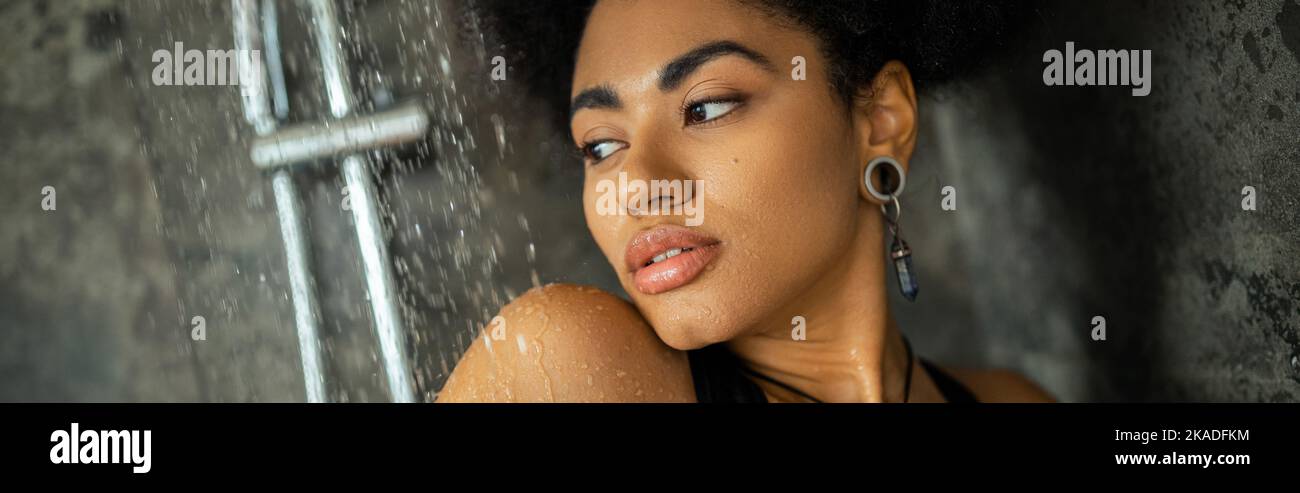 Pretty african american woman standing under water while taking shower, banner,stock image Stock ...