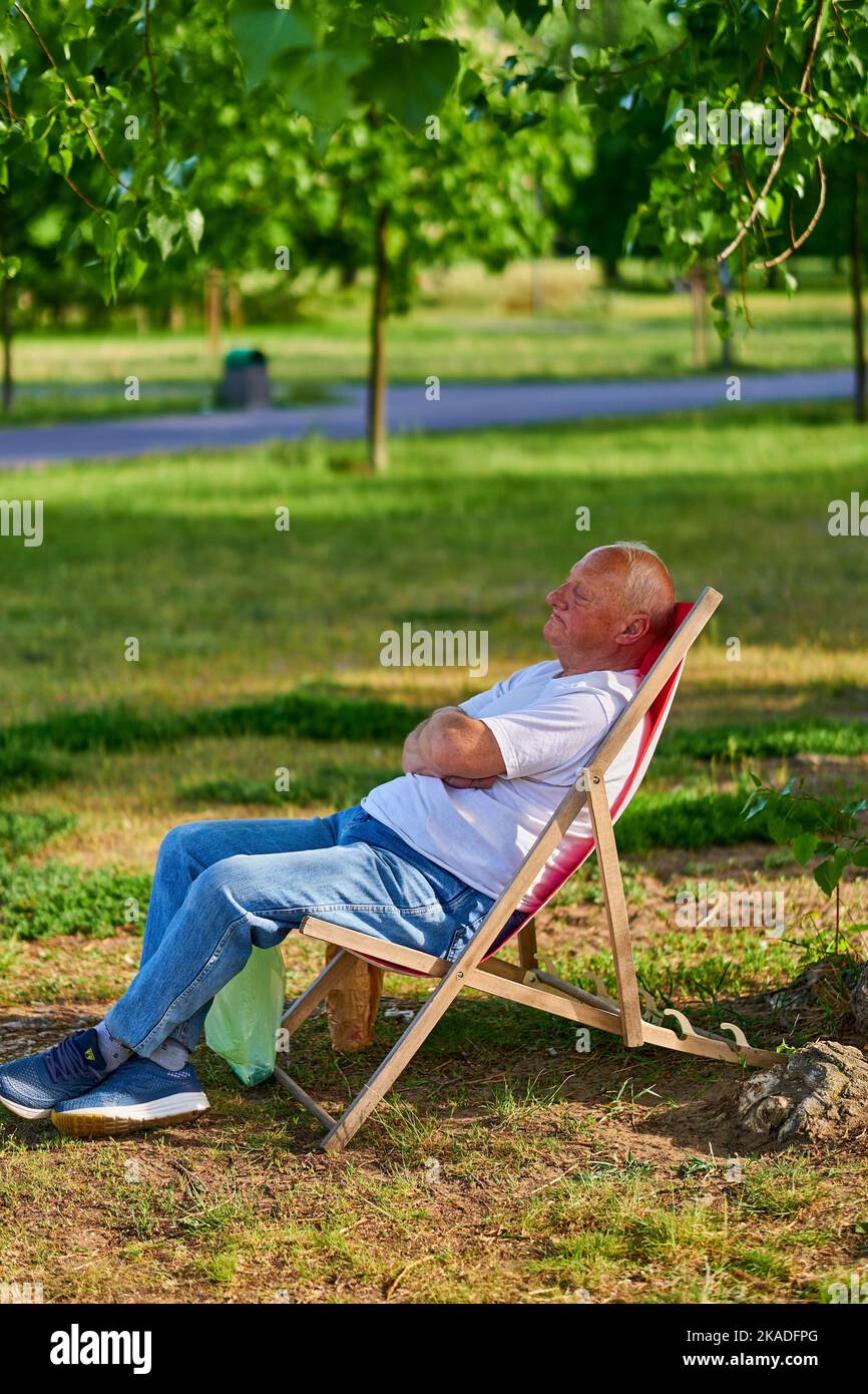 Old man sleeping on chair hi-res stock photography and images - Alamy