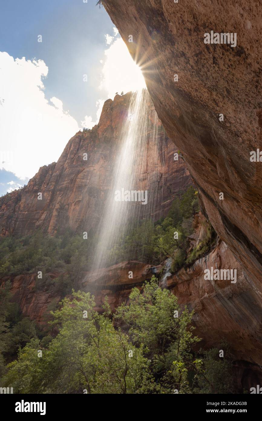 Small beautiful waterfalls flowing over the red sandstone cliffs of the ...