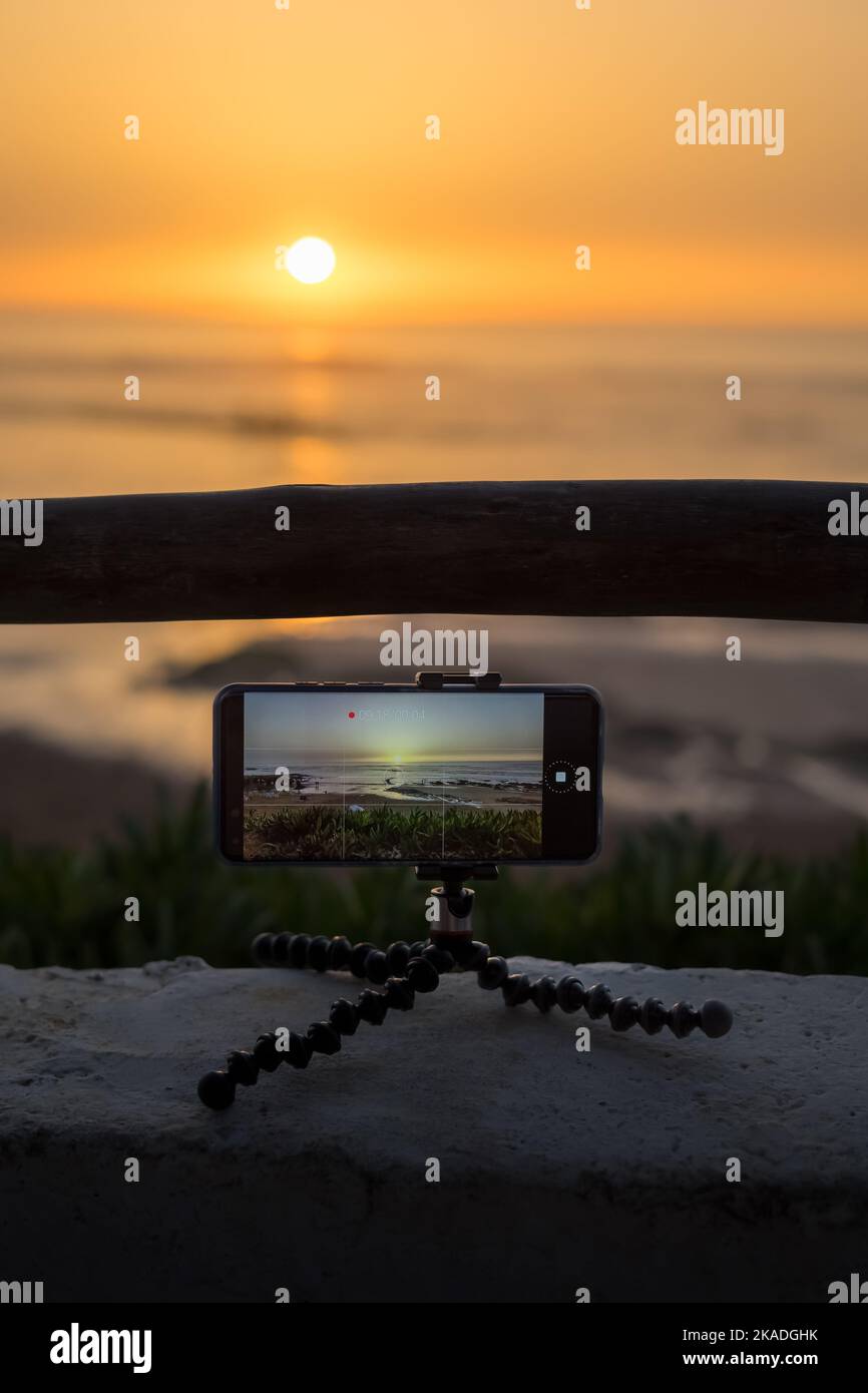 Smartphone shoots a Timelapse of the sunset over the sea Stock Photo ...