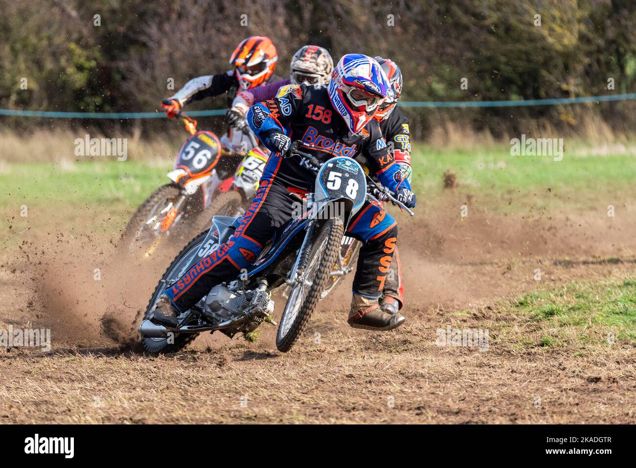 Riders racing in grasstrack motorcycle race. Donut Meeting event ...