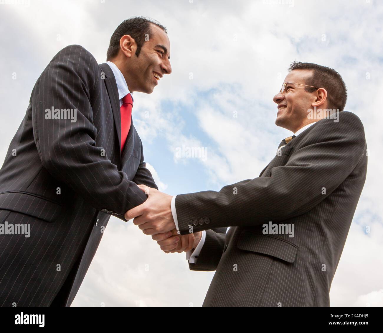 Business Partners. A warm and friendly handshake between agreeable business colleagues, low ...