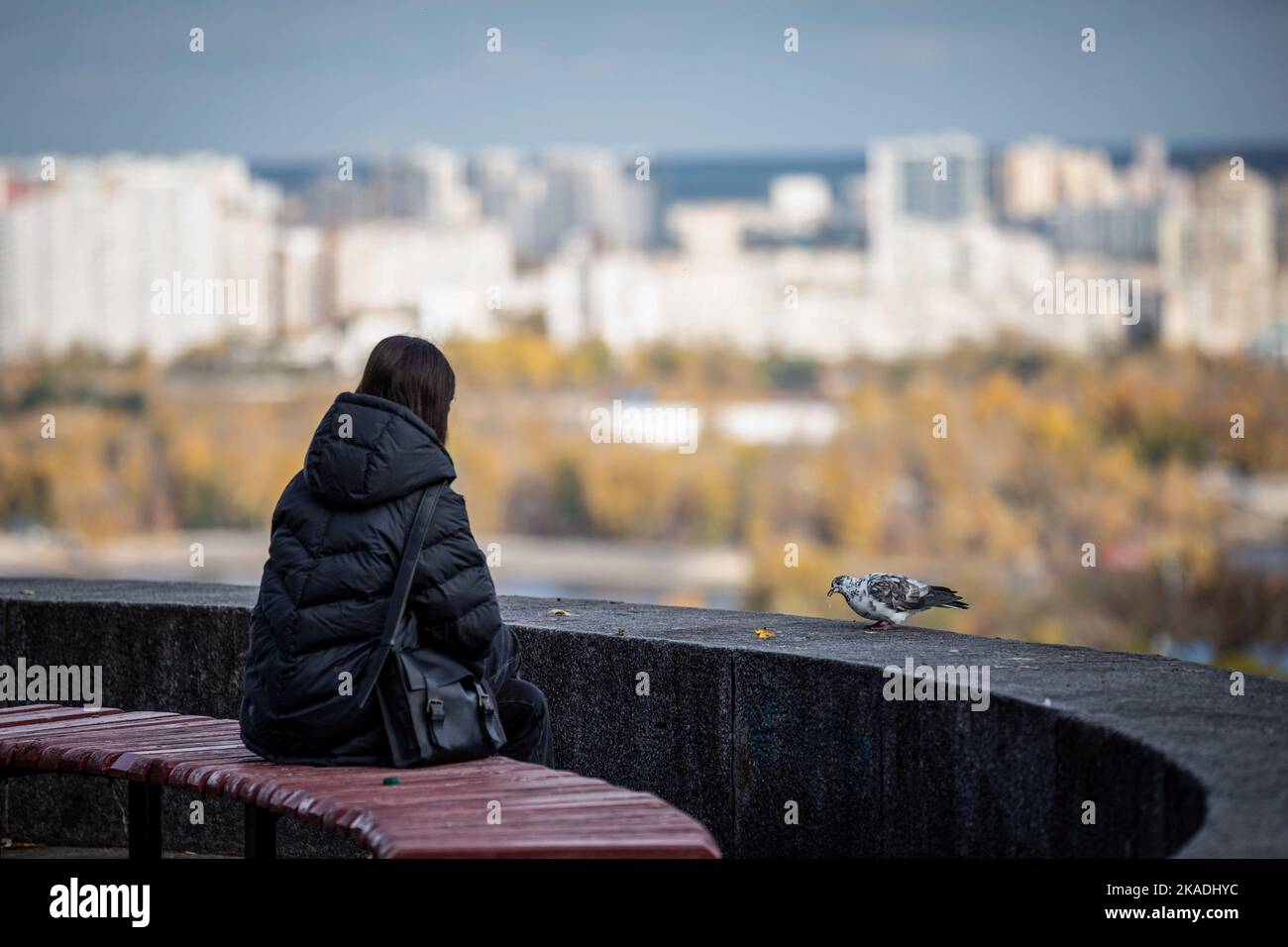 Girl sits on a bench in a park in central Kyiv. In October 2022, the ...