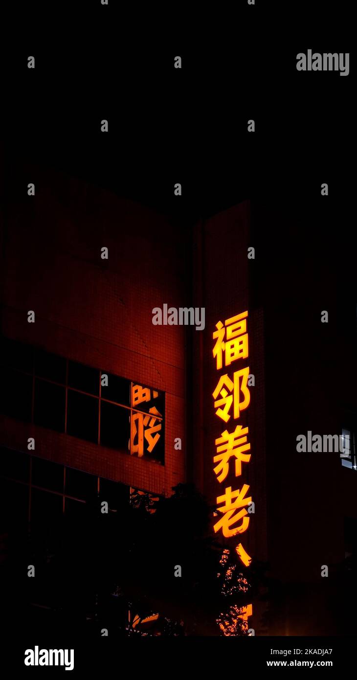 A vertical shot of a neon sign with Chinese logograms Stock Photo - Alamy