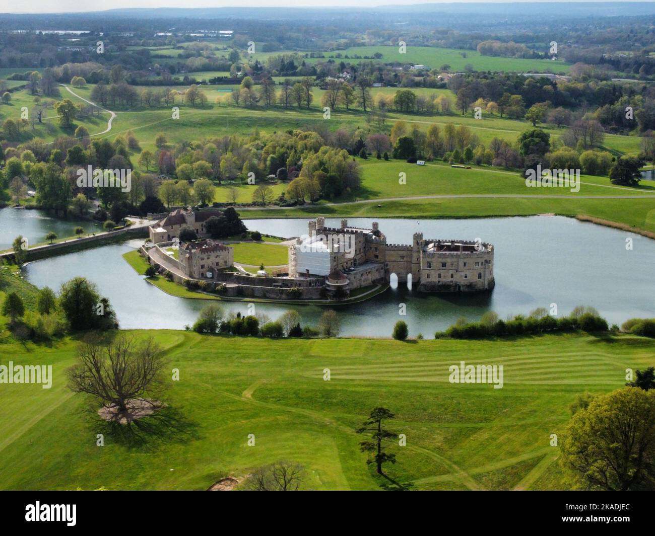 The bird's eye view of the Leeds Castle on the lake surrounded by green ...