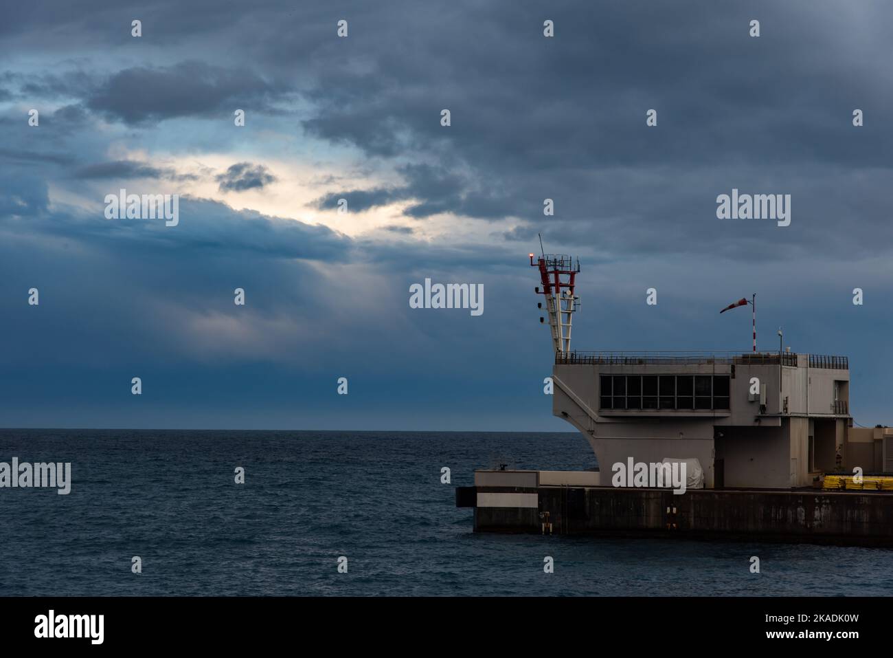 The part of the building on the shore against the cloudy sky and the ...