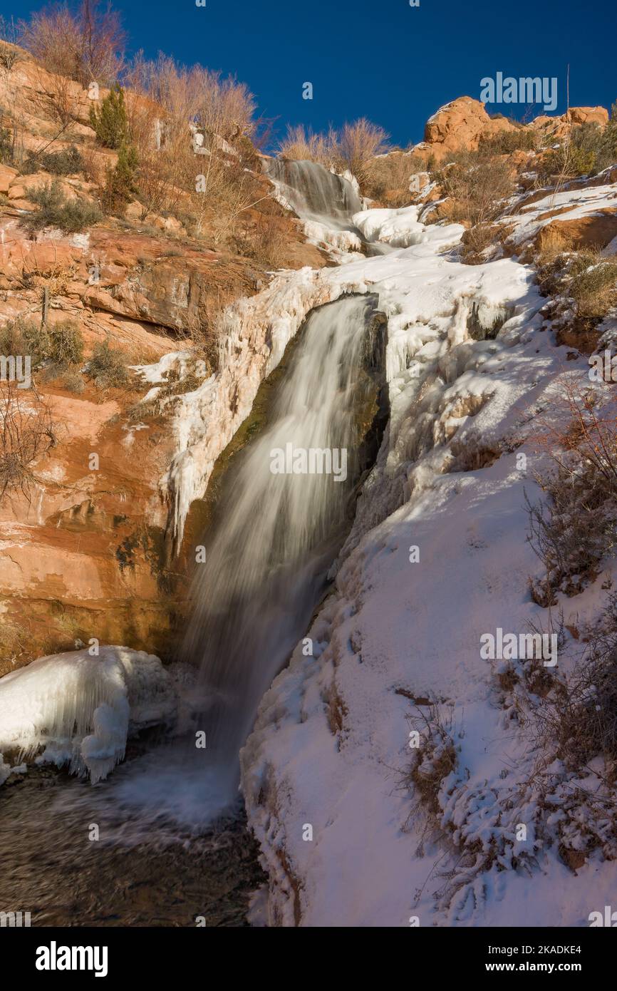 Partially frozen Faux Falls in winter in the desert near Moab, Utah ...