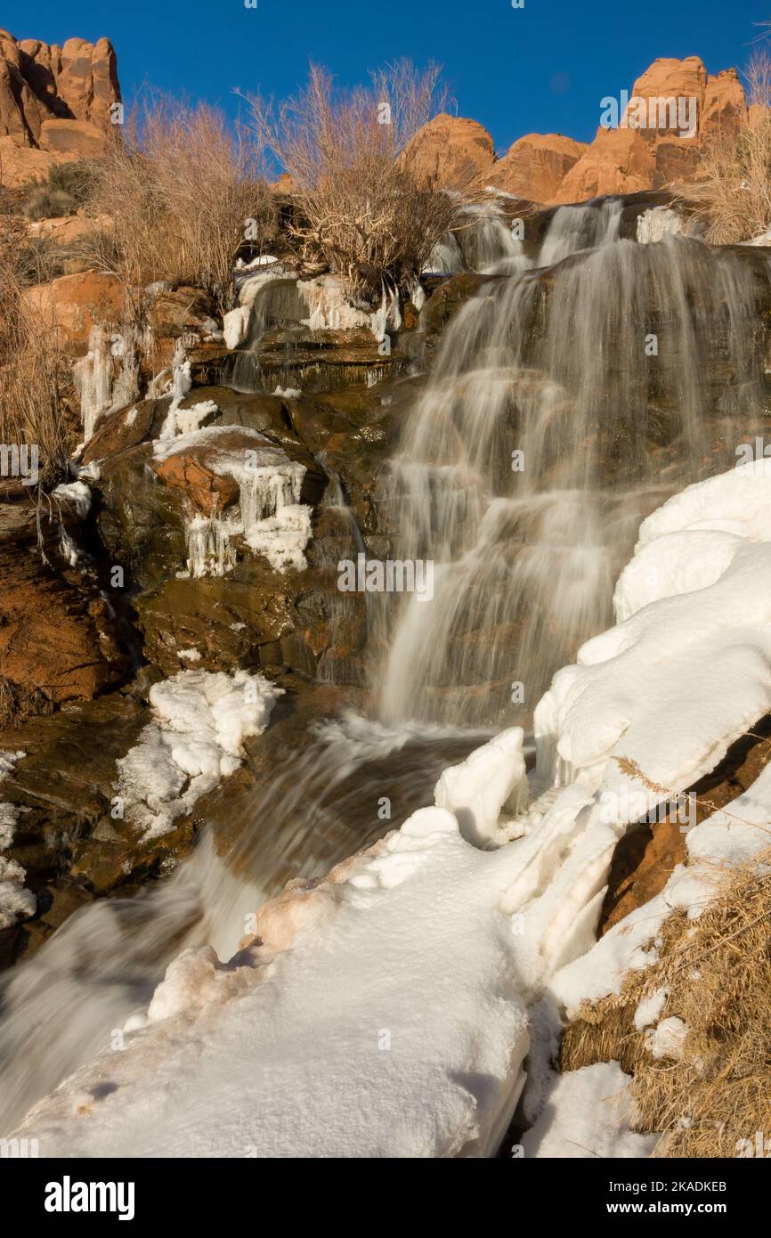 Partially frozen Faux Falls in winter in the desert near Moab, Utah ...